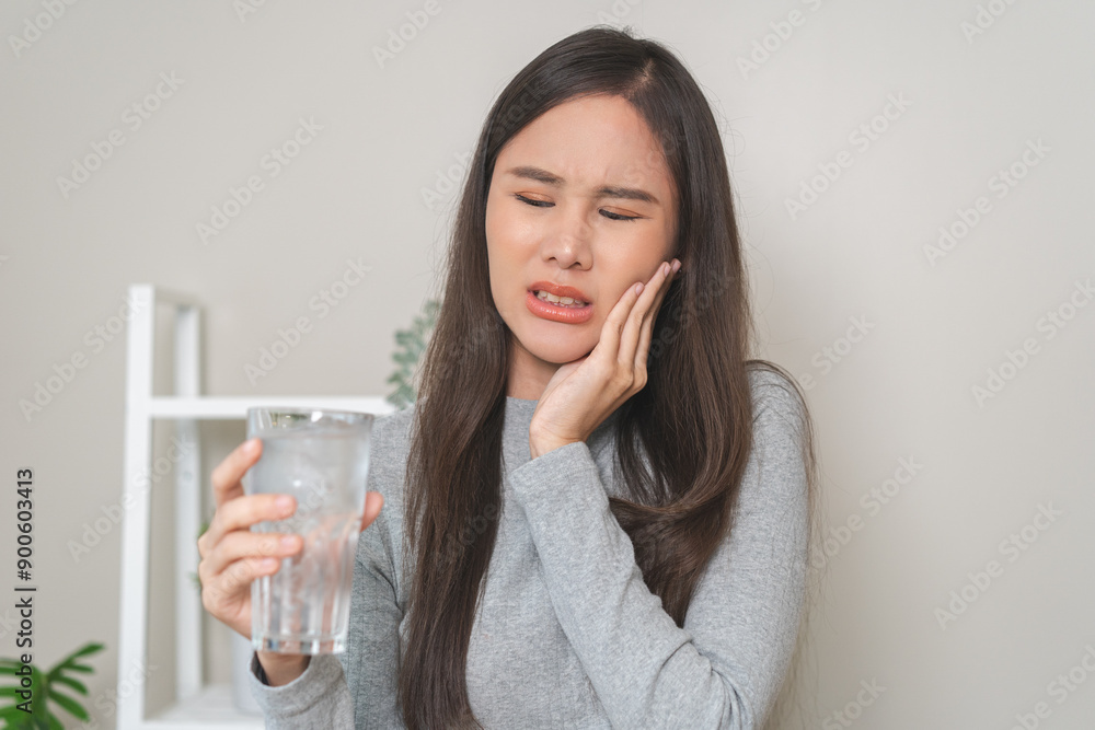 Suffering from toothache, hurt asian young woman touch cheek, face ...