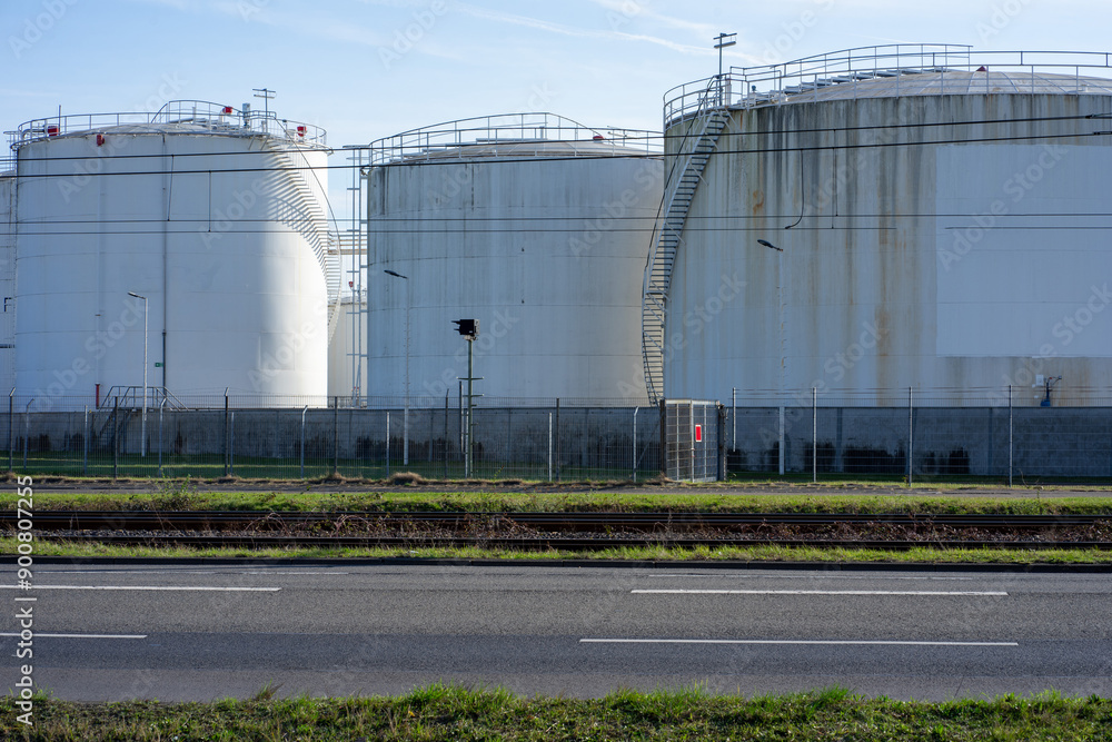 Large white industrial storage tanks with a background of clear blue ...