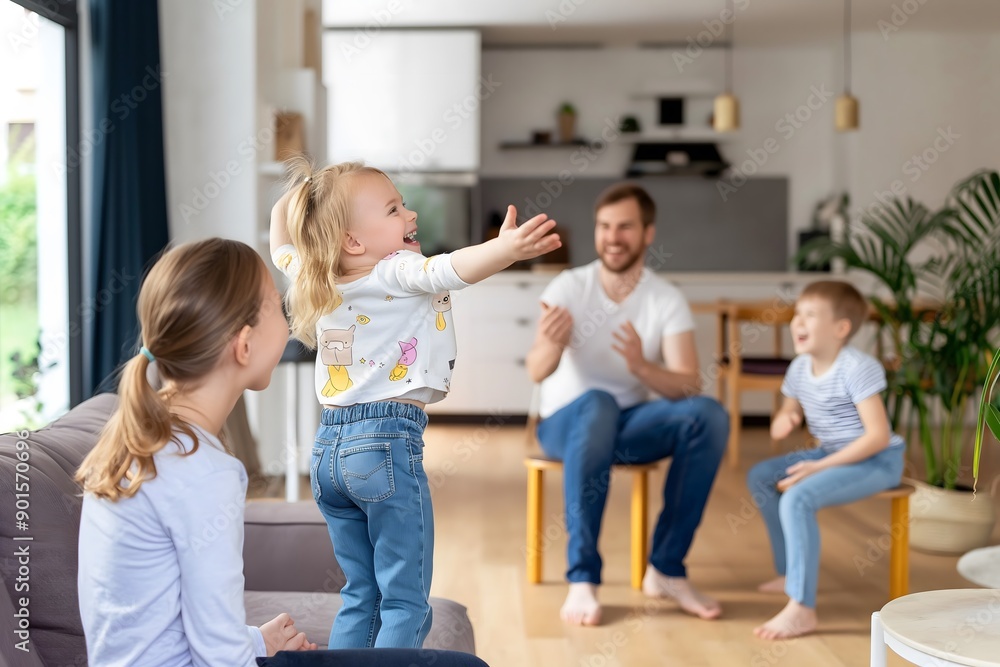 A young nuclear family has fun at home, spending a weekend day indoors ...
