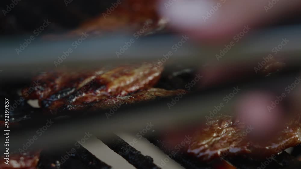 During the sunset, a woman grilled barbecue on a gas grill in the front ...