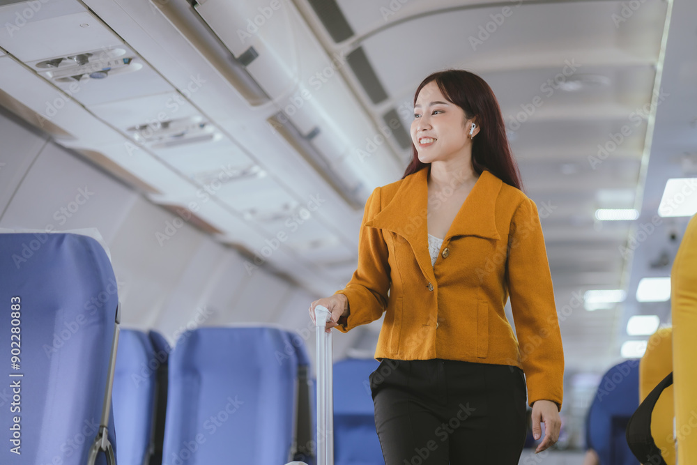 A beautiful young woman at the airport is excitedly boarding the plane ...