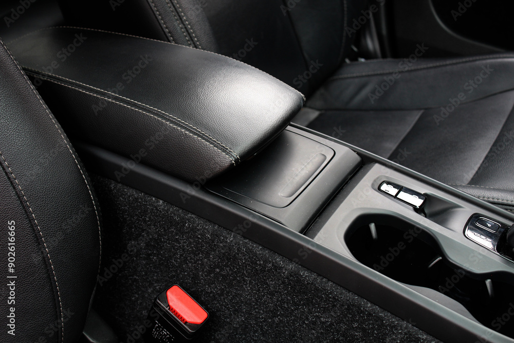 Leather modern car interior. Electric car armrest with storage box ...