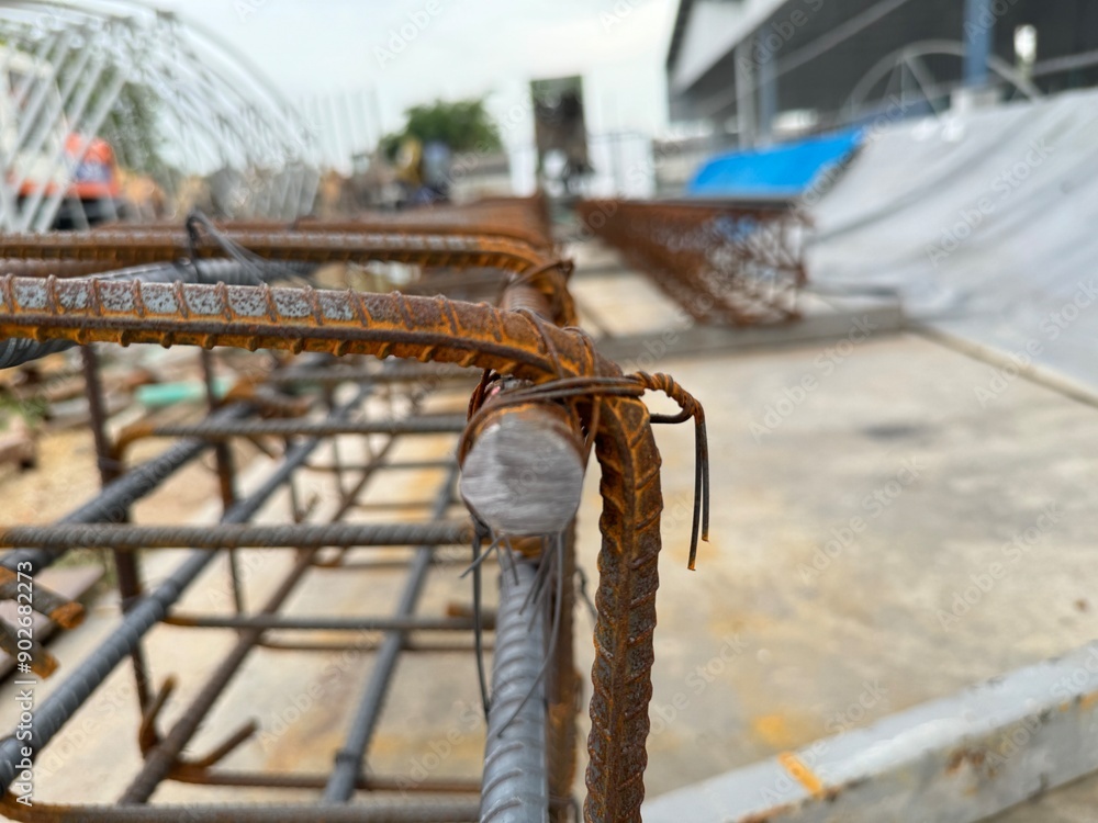 Close-up on rusted rebar awaiting concrete pour at construction site ...