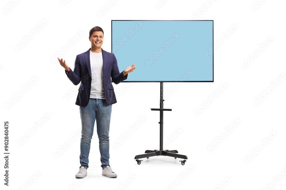 Full length portrait of a happy young man in jeans and suit presenting ...