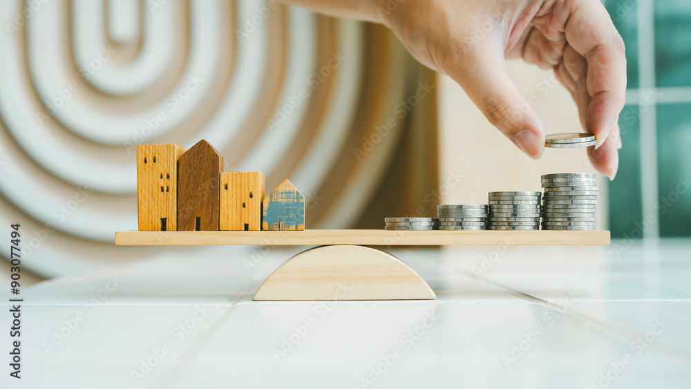 Wood house and Coins stack with balance scale. Money management ...