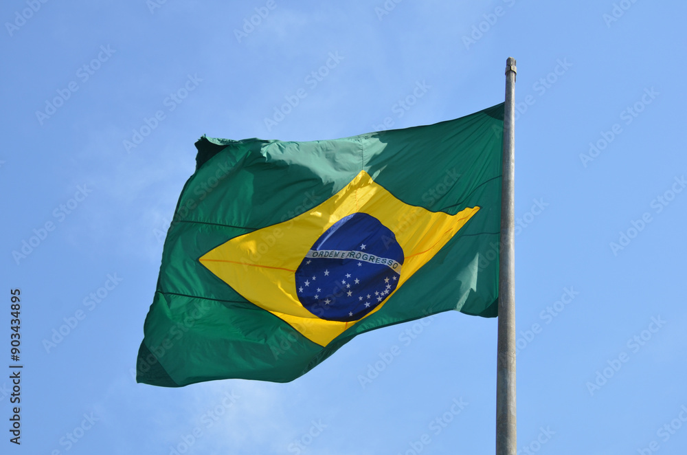 Flag of Brazil fluttering in the wind. In the center of the flag with ...