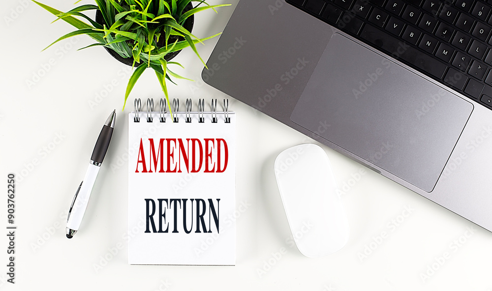AMENDED RETURN text on a notebook with laptop, mouse and pen . Stock ...