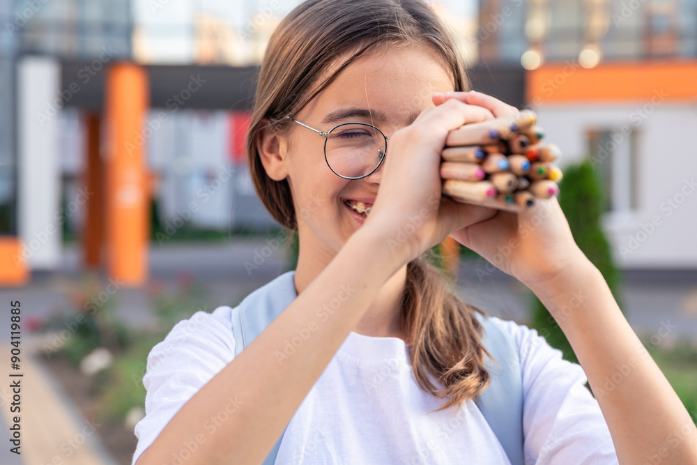 Schoolgirl with pencils in hands close-up. Student with school supplies ...