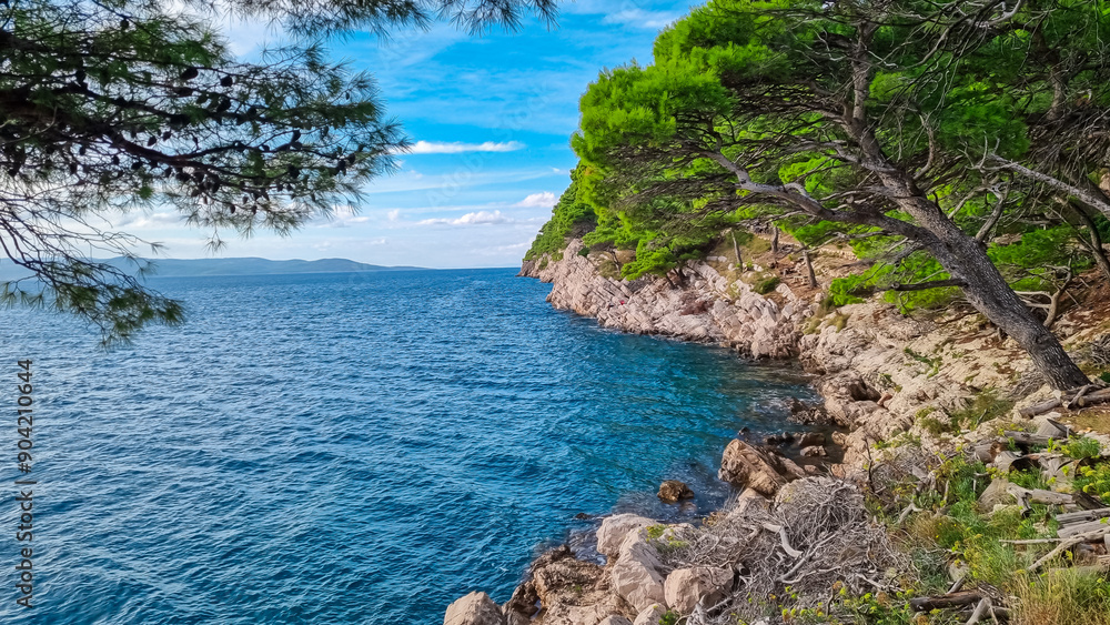 Breathtaking coastal vista featuring a rugged cliff rising dramatically ...
