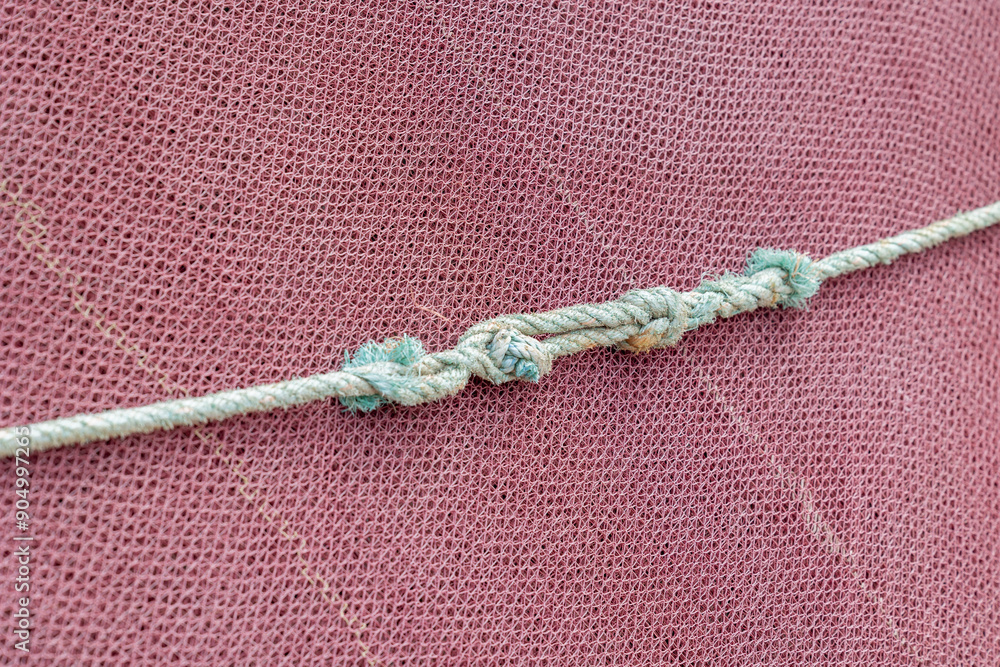 This is a high-resolution close-up image depicting knotted ropes ...