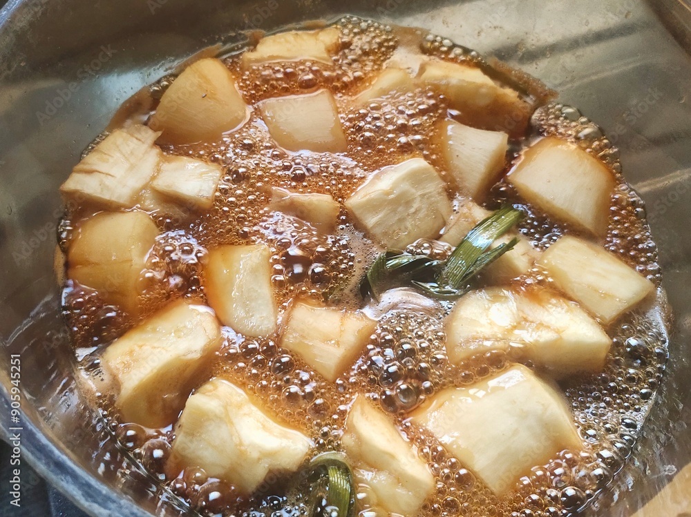 The process of making Boiled Cassava with Palm Sugar, is a traditional ...