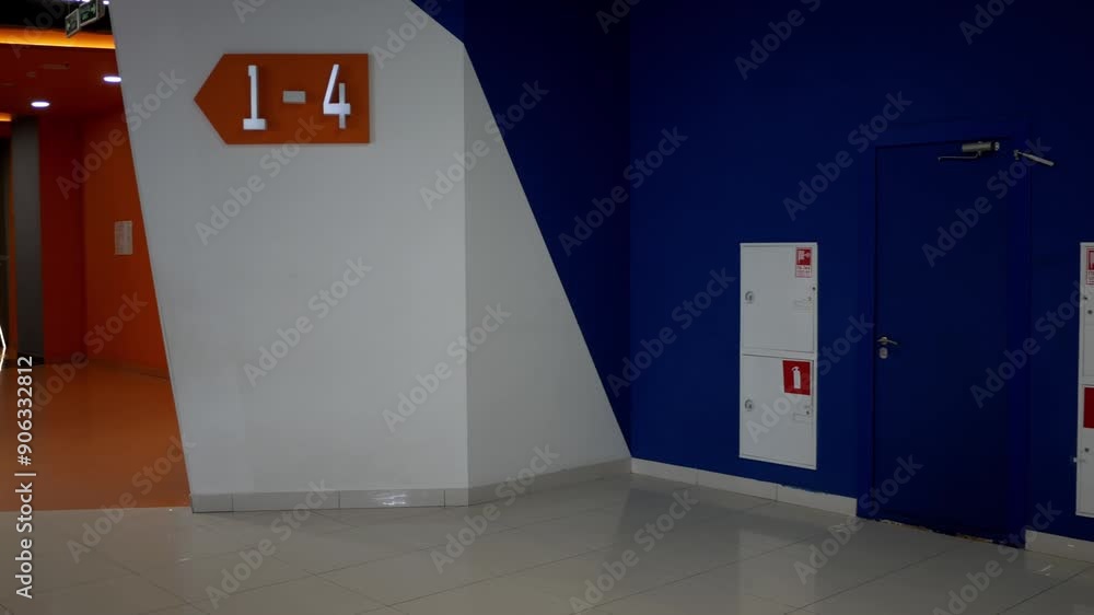 Emergency exit door and fire extinguisher at movie theater. Exit doors ...