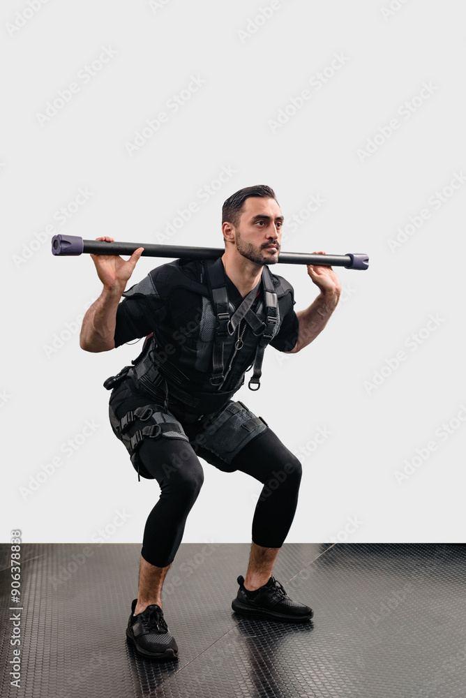 Fitness athletic man in electrical muscular stimulation suit training ...