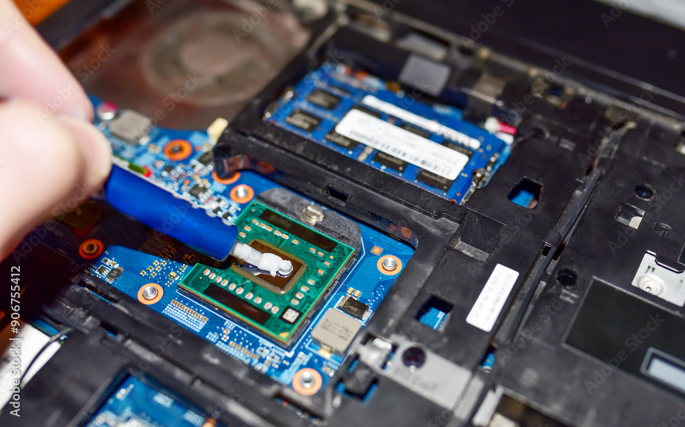 Applying thermal paste to a chip in a computer. Thermal grease syringe ...