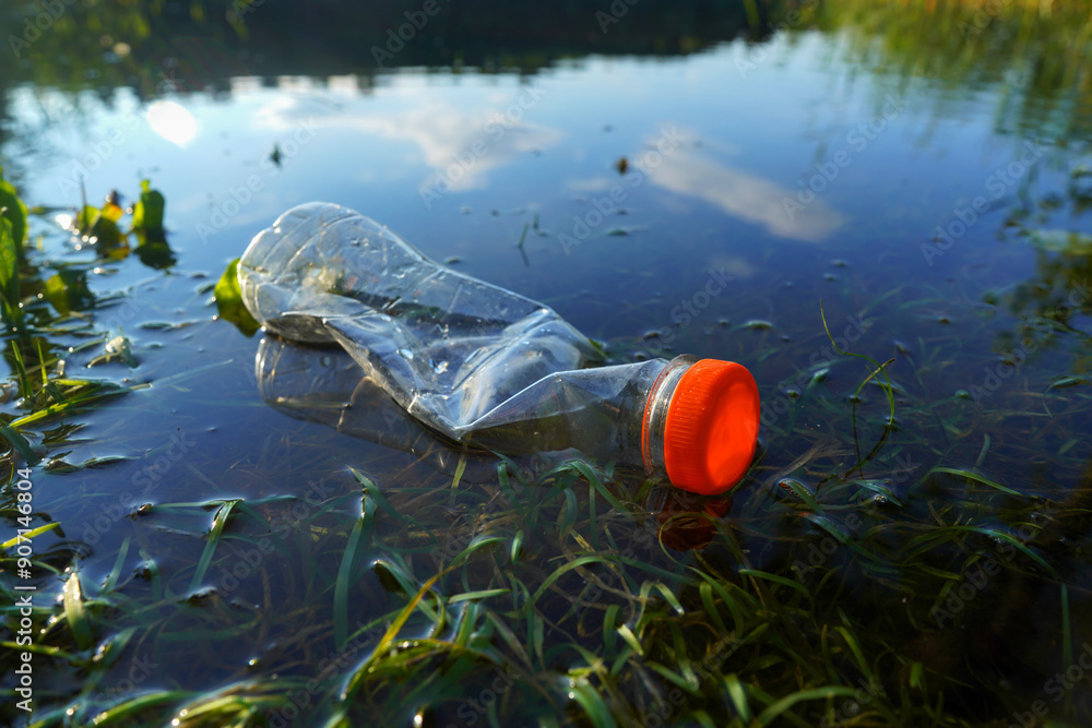 Plastic bottle waste in lake. Marine plastic pollution. Microplastics ...