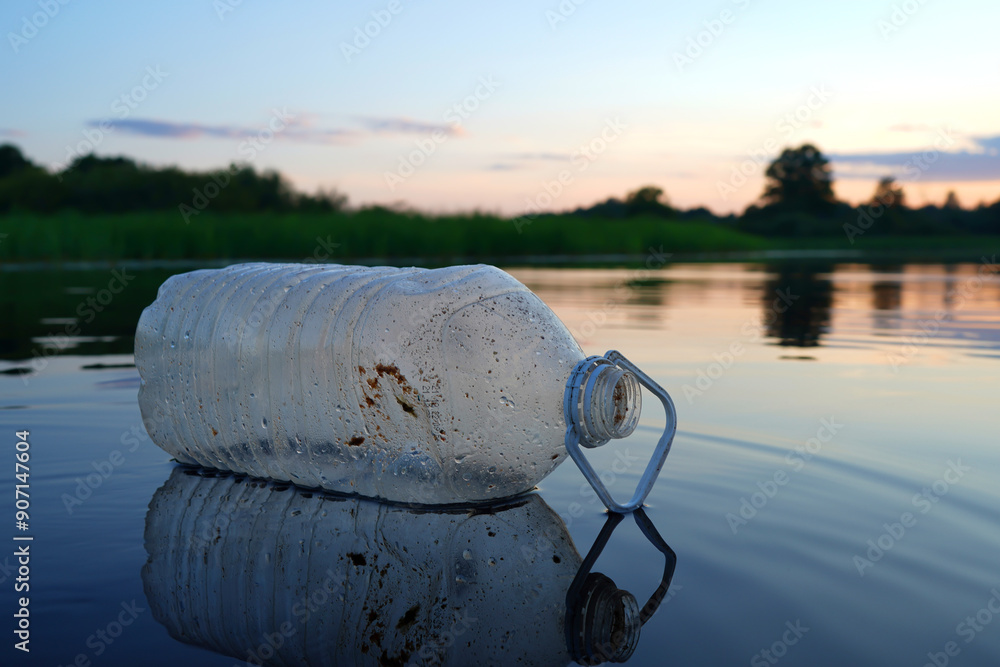 Plastic bottle waste in lake. Marine plastic pollution. Microplastics ...