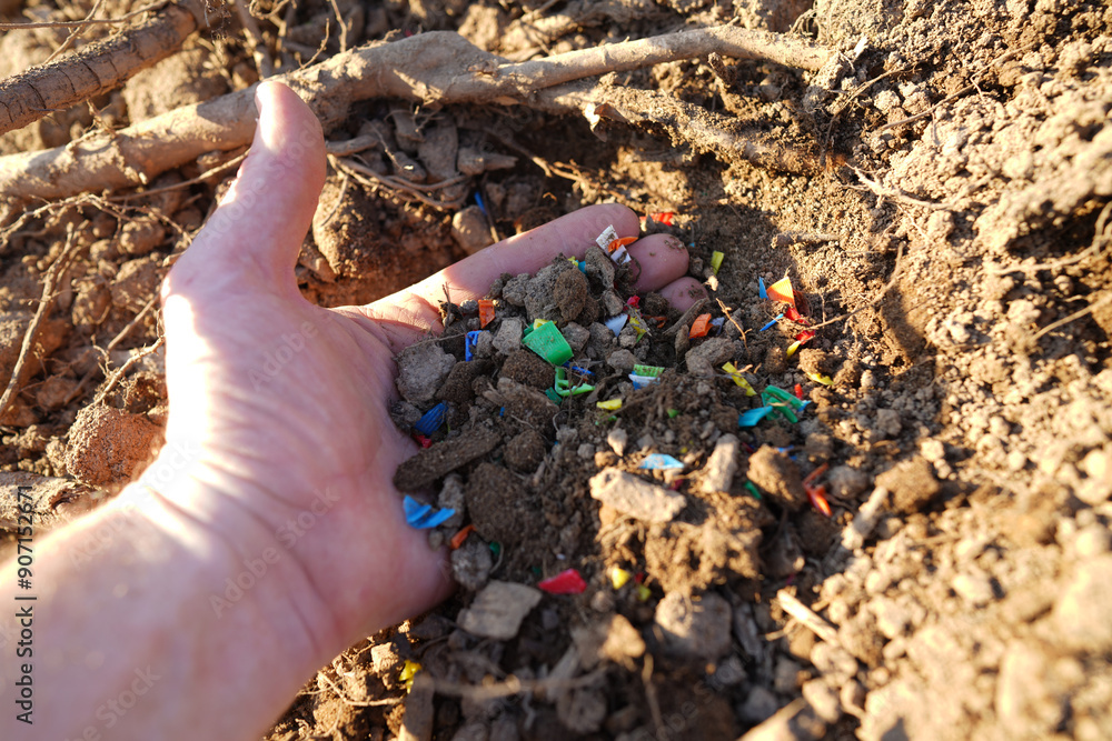 Microplastic pollution. Microplastics in ground. Soil contaminated with ...