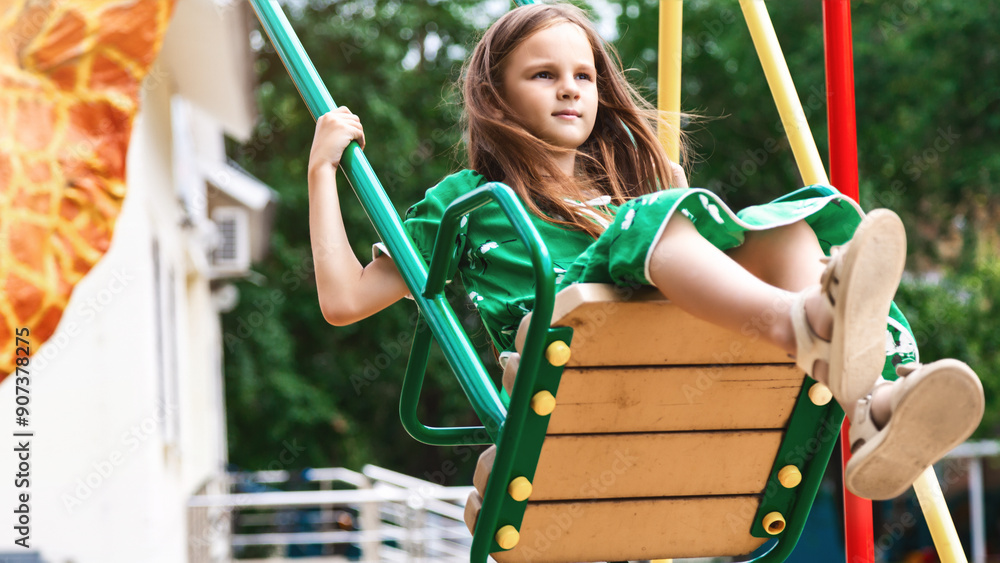 Child playing on outdoor playground. Kids play on school or kindergarten yard. Active kid on ...