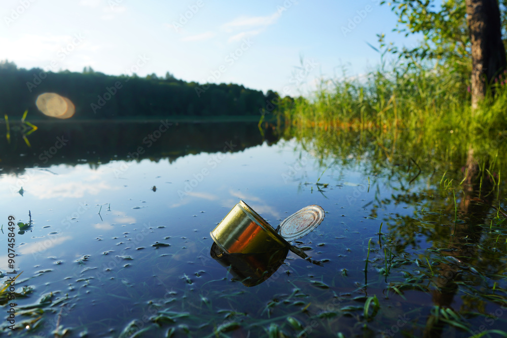 Tin can waste in lake. Empty metal tin can garbage, food waste in ocean ...