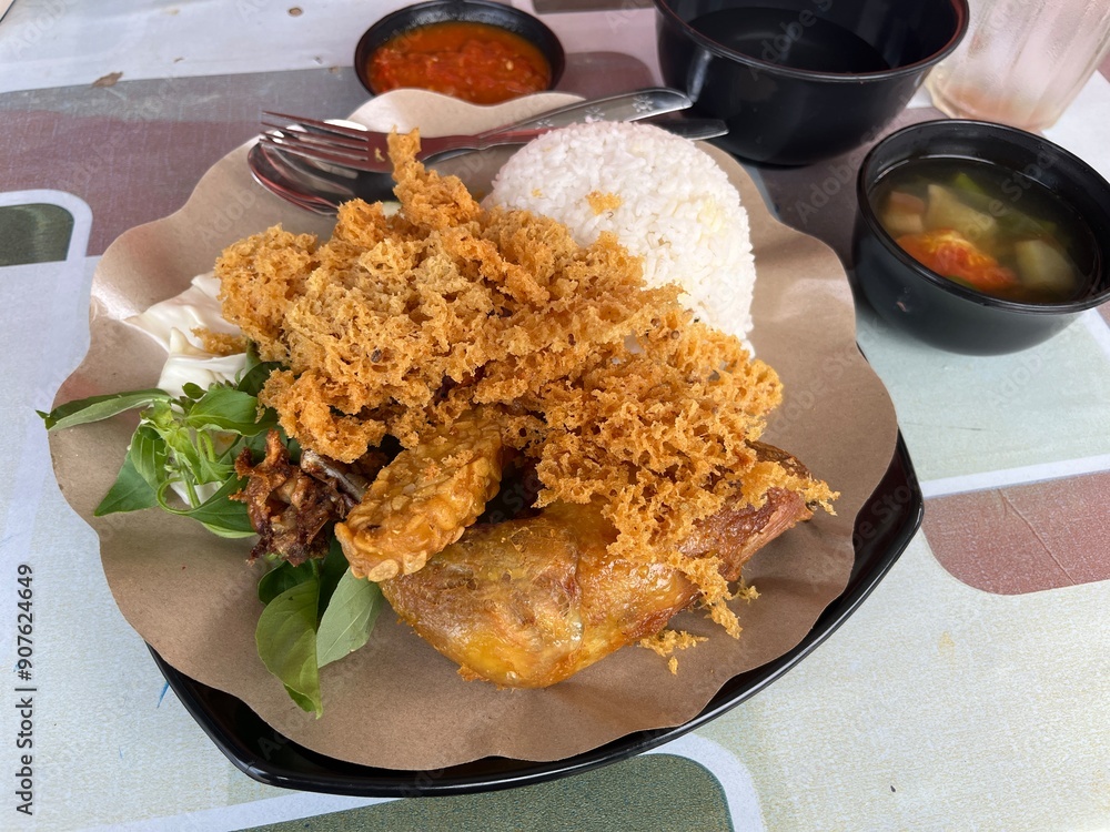 Ayam Goreng Kremes. Popular fried chicken dish from Jogjakarta, deep-fried whole chicken and ...