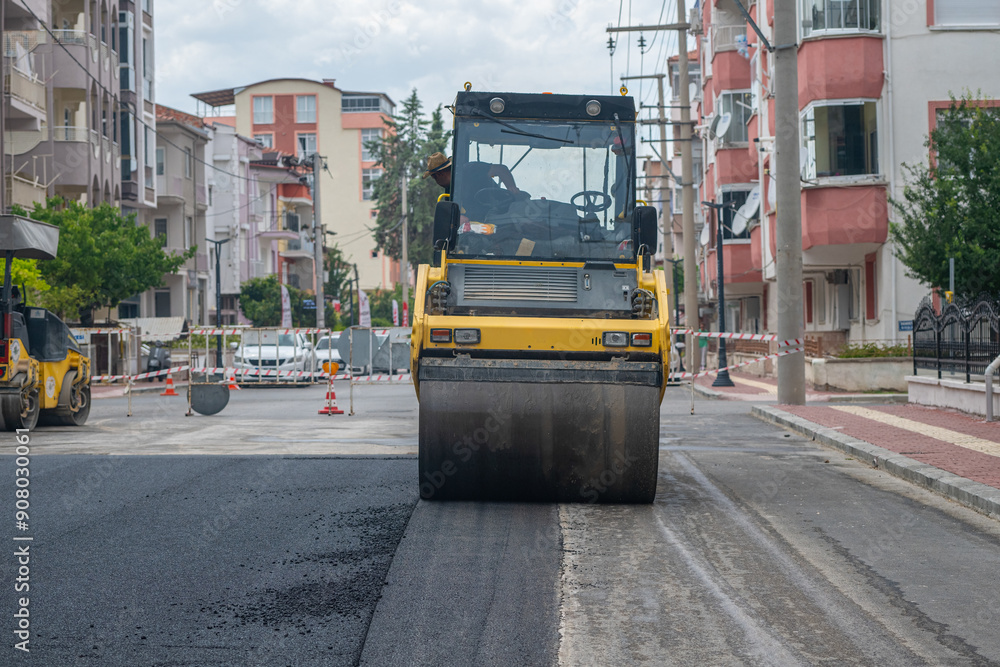 Operation of roller and asphalt paver machine during road construction ...