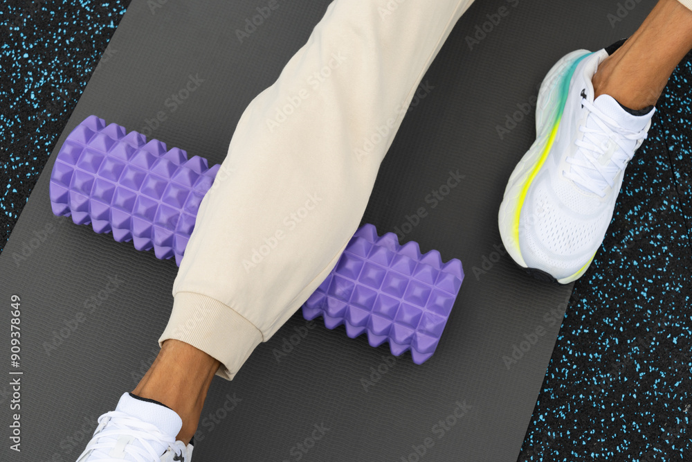 Athlete man stretching legs and check trigger point on foam roller on ...