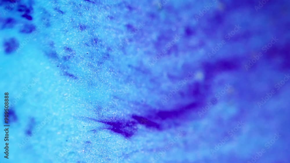 Sequin paint mix. Ink spill. Sparkling fluid. Defocused blue purple ...