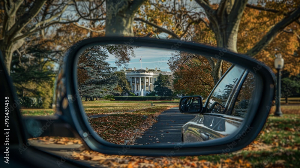 A car's rear view mirror shows a reflection of the White House. Concept ...