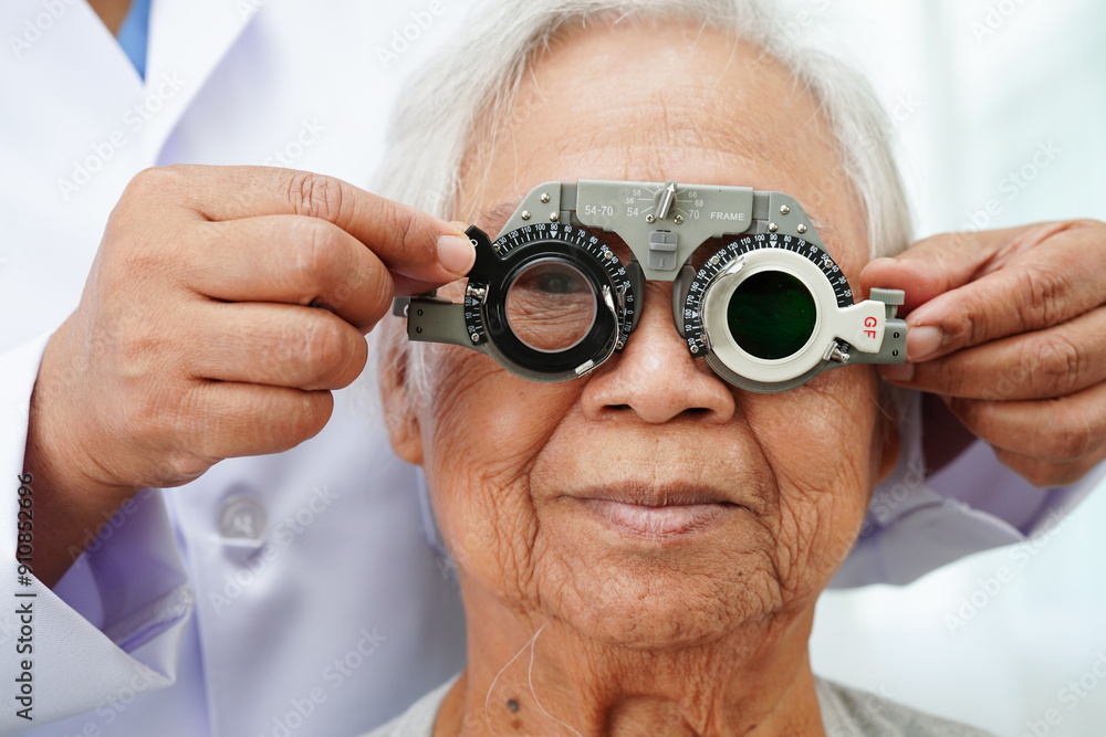 Optometrist checking Asian elderly woman ophthalmic vision eye test and ...