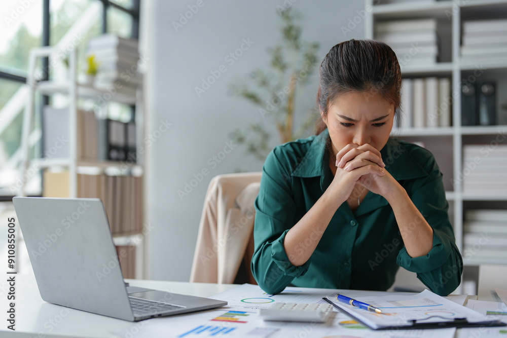 Asian businesswoman who is tired and sleepy from sitting at a desk for ...