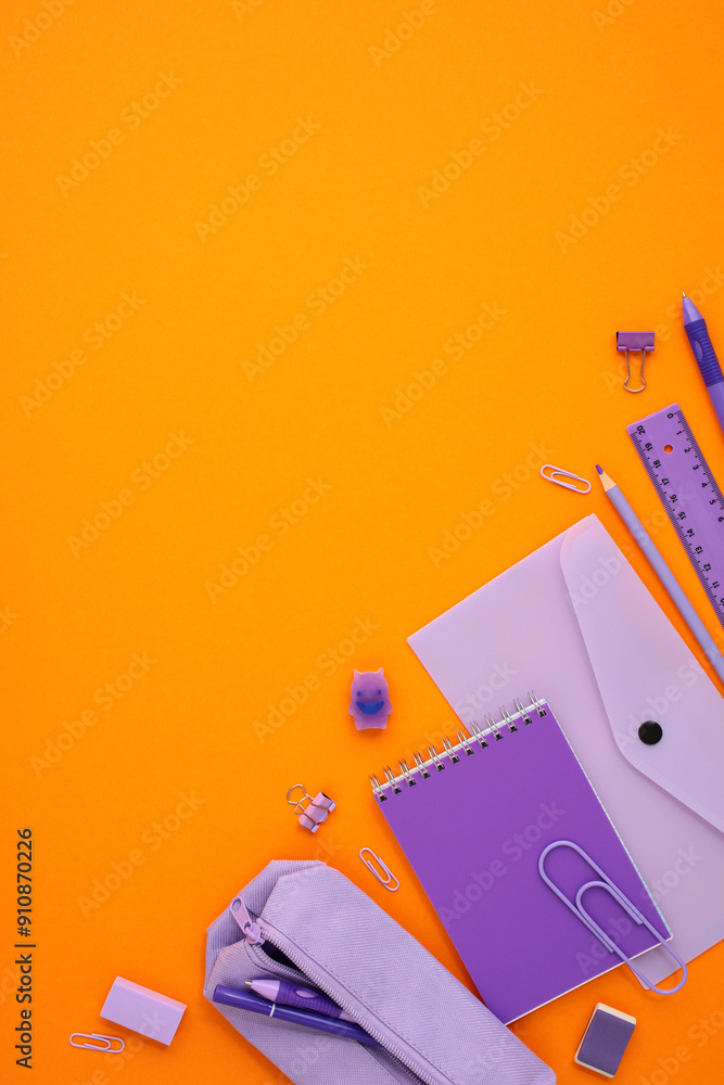Purple school supplies on vertical orange background. Flat lay, top ...