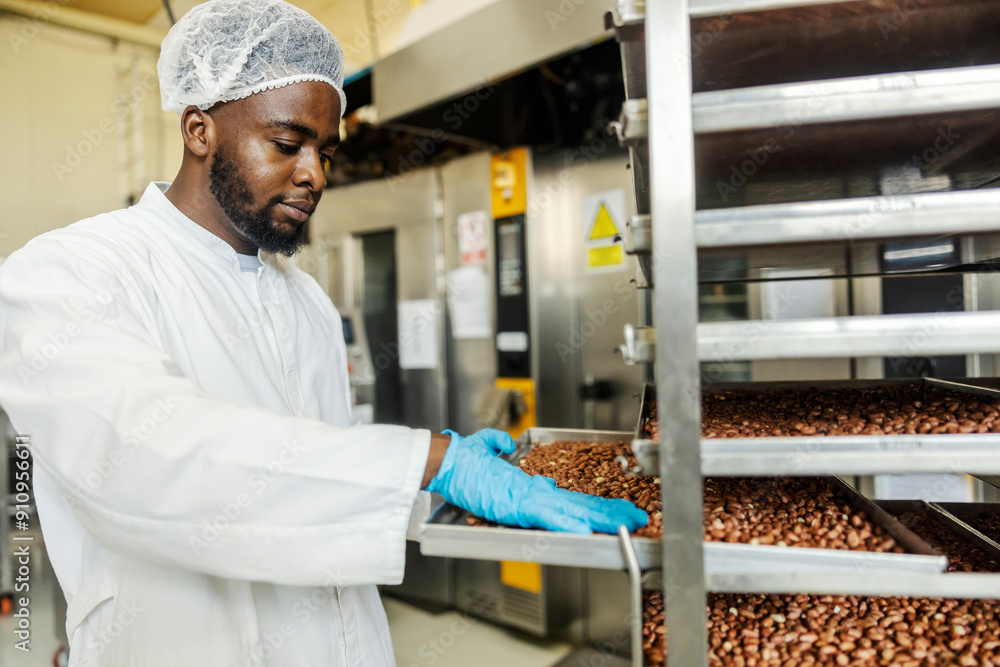 Portrait of multicultural food factory worker baking peanuts and ...