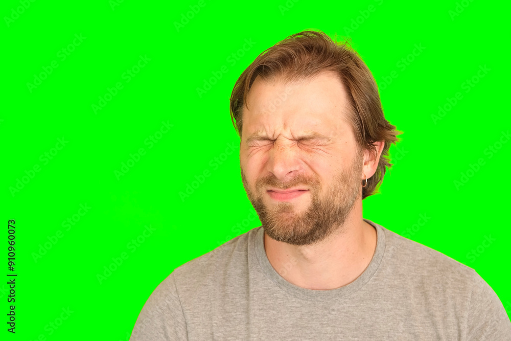 Upset man over plain green background. Adult bearded fun confused shy ...