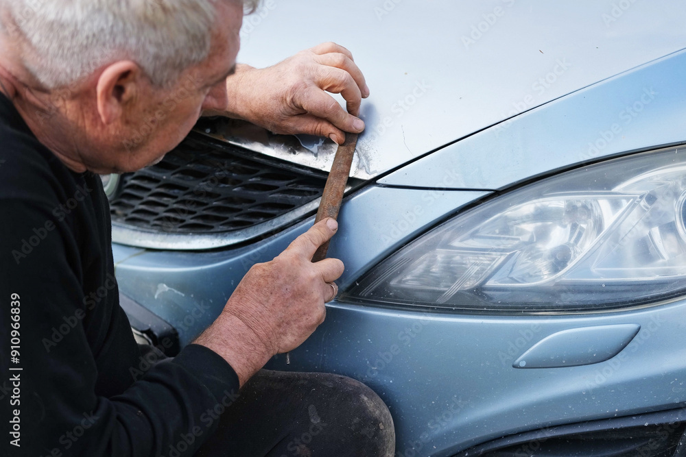 Car body shop. Repair man processes the welding seam using an angle ...