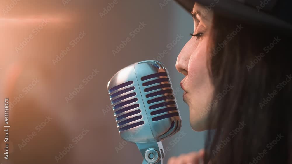 Close side view of a woman in a black hat blowing a kiss to a vintage ...