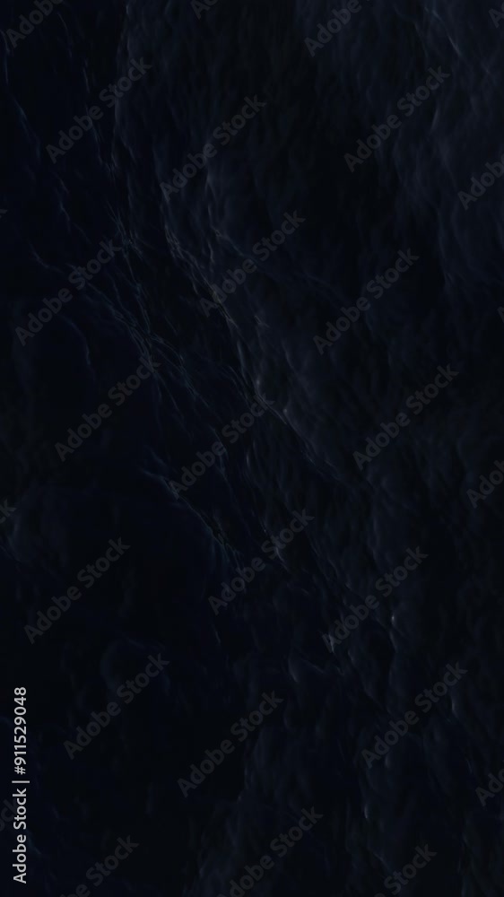 Vertical aerial view of the dark ocean. Ripples and waves on deep water ...