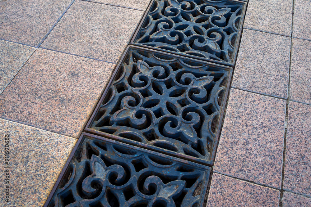 Grate the park's rainwater drainage system at the sidewalk. Square ...