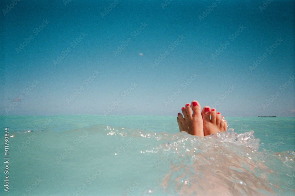 POV film photo of feet floating in the ocean in Abacos, Bahamas Stock ...