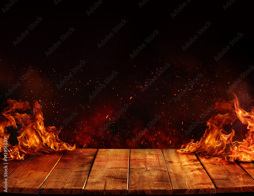 wooden table with Fire burning at the edge of the table, fire particles ...