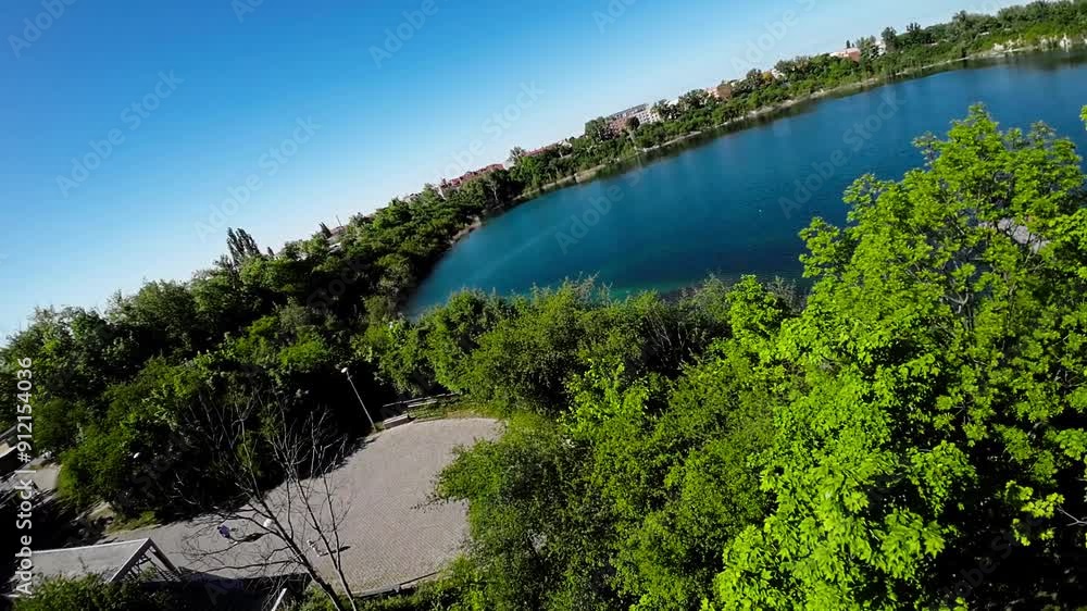 A park with a lake in Opole, Poland. The park is full of lush greenery ...