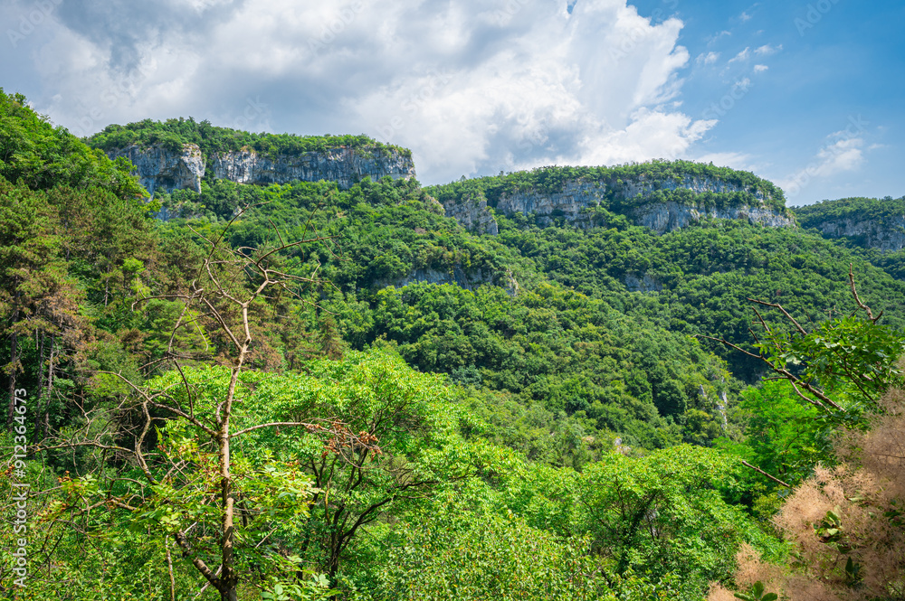 Densely vegetated rocky mountains in the Molina waterfall park, north ...
