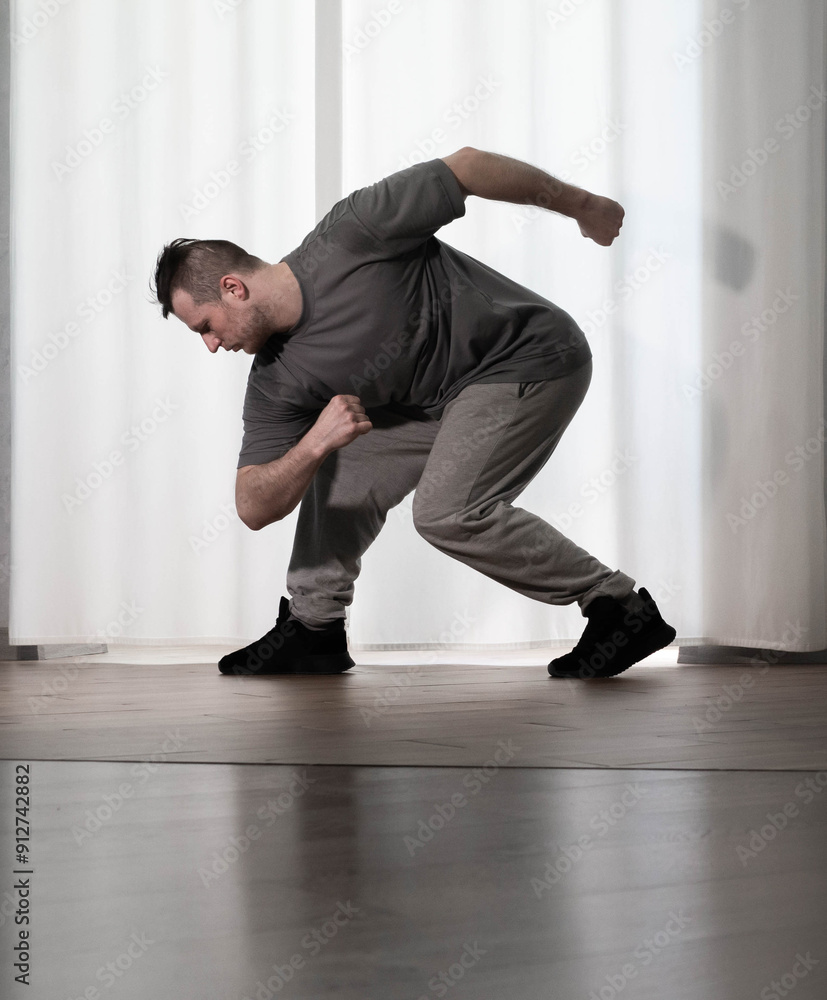 Dance in motion, pose of a man in hip-hop style clothes. Sports dancing ...