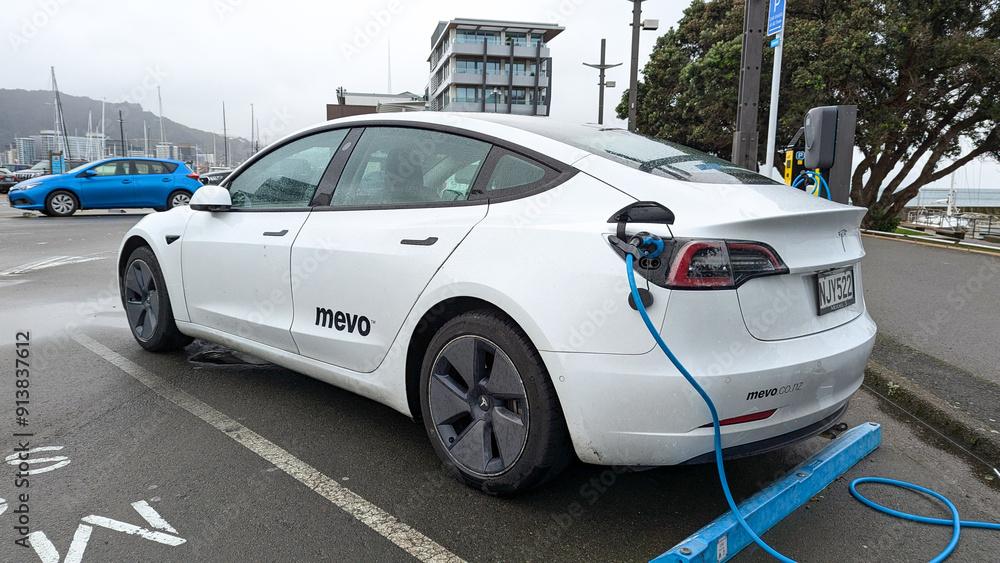 Tesla MEVO EV electric vehicle rental hire car at charging station in ...