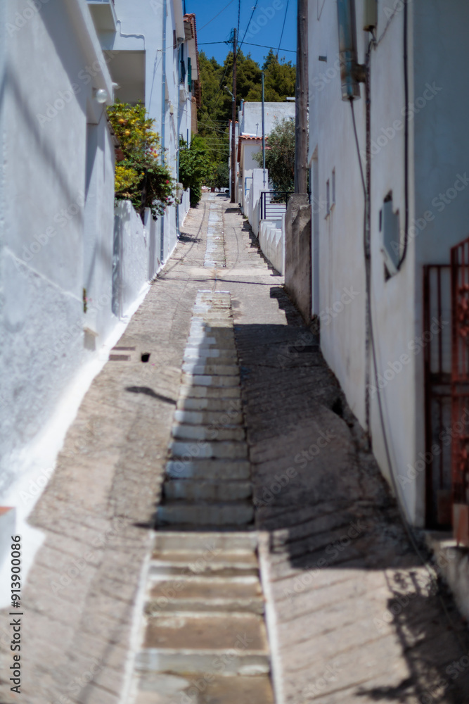 Whitewashed stone steps leading up a hillside street in a Greek island ...