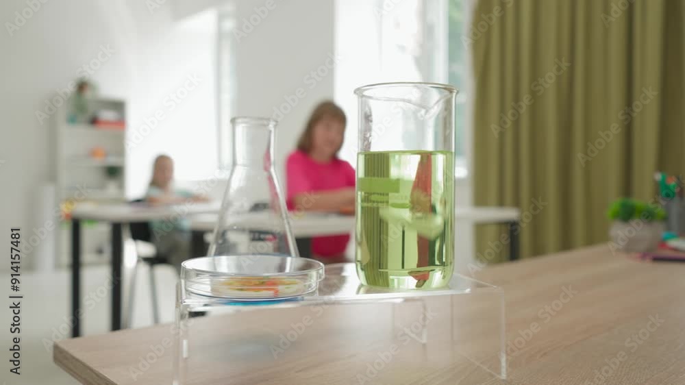 Junior school children sitting in classroom on science chemistry lesson ...