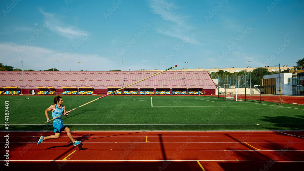 Motivated young athlete practicing for pole vaulting championship ...