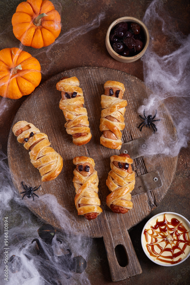 Halloween food: sausages baked in a puff pastry dough cover in a shape ...