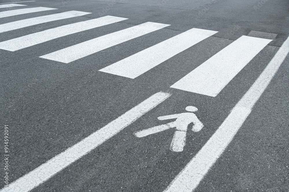 pedestrian sidewalk walkway and crosswalk markings on a narrow asphalt ...