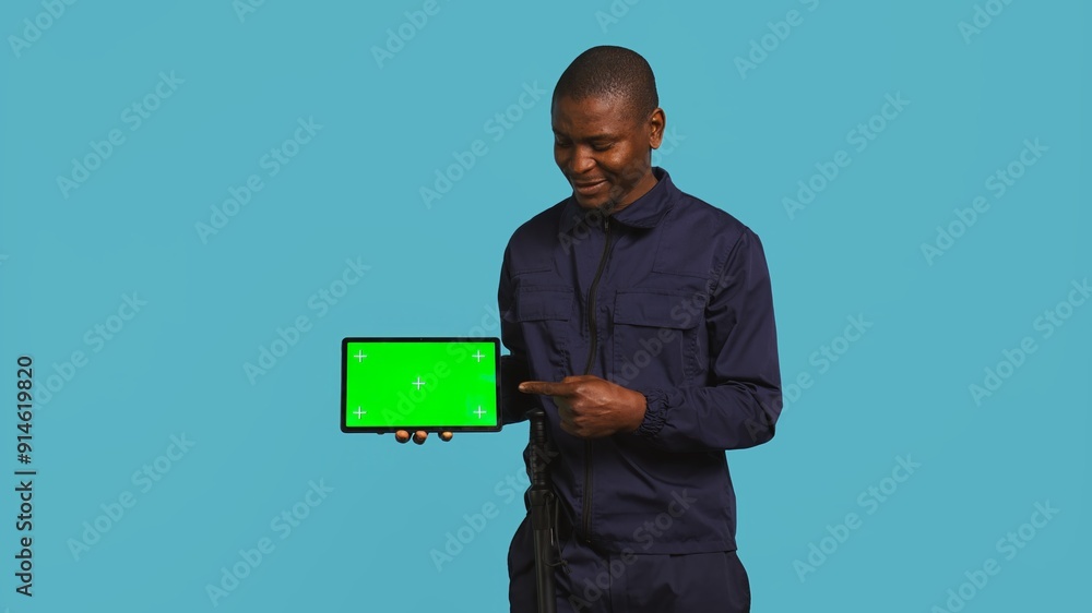 Portrait of happy security staff member showing isolated screen tablet ...