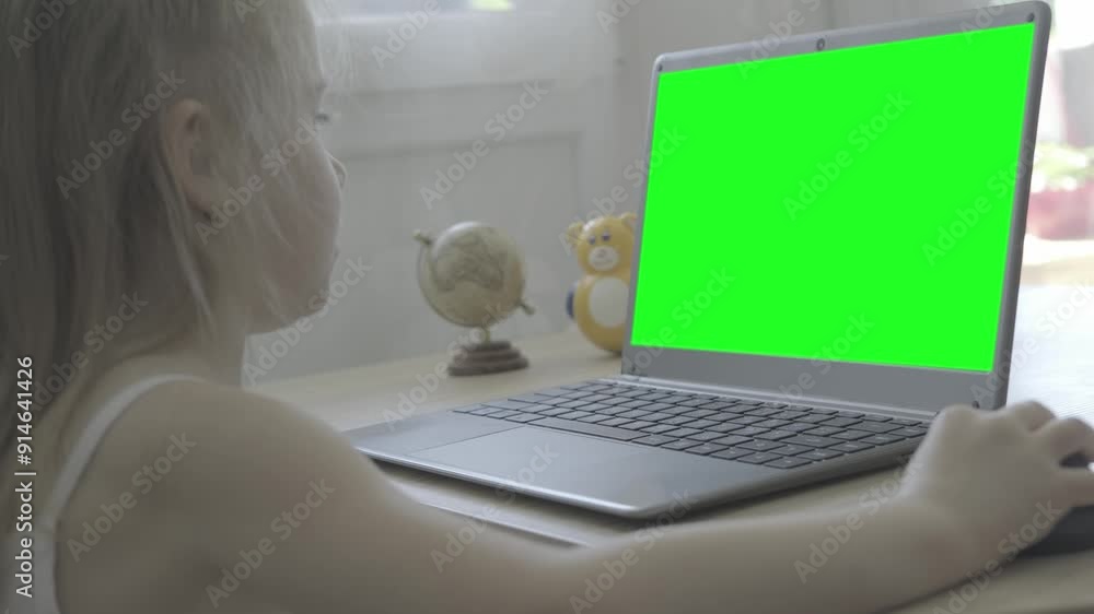 green screen display for video, smart 5-year-old child uses computer ...